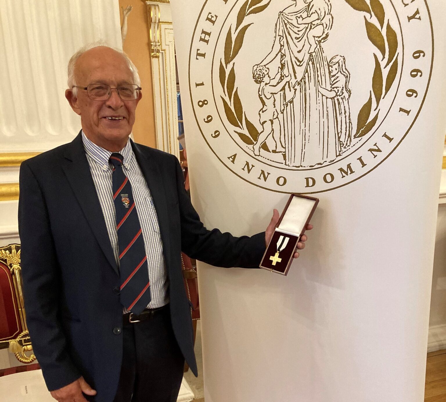 David Kitching is presented with a League of Mercy medal for the huge ...